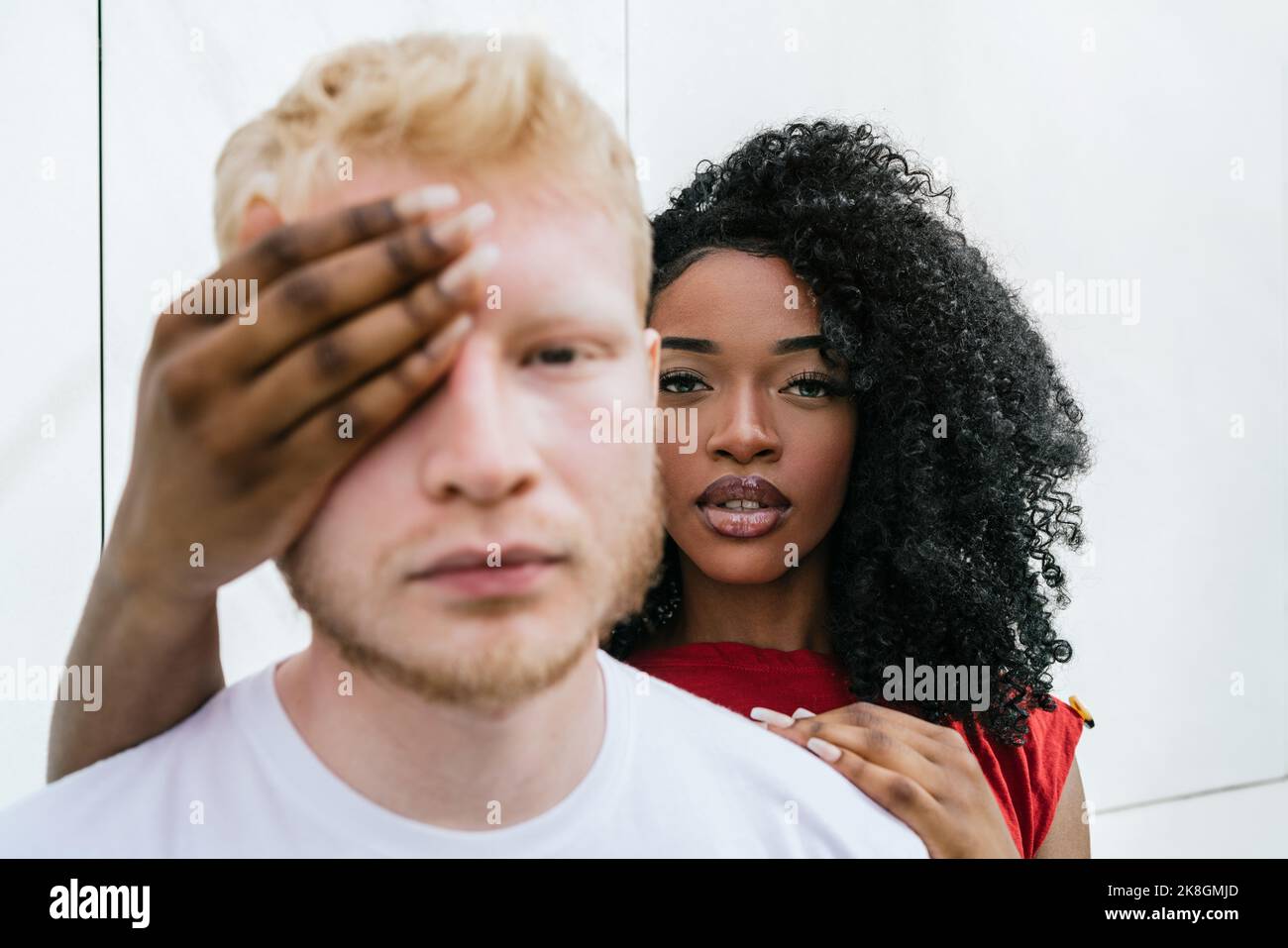 Unemotional African American girlfriend with makeup covering eyes of ...