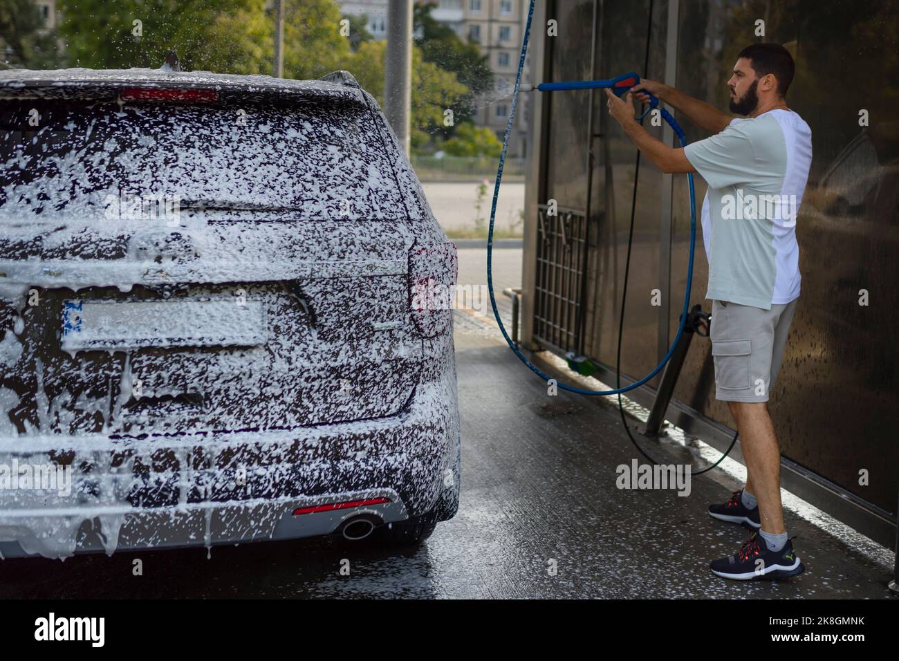 Man Washing A Car In A Self Service Car Wash Station With Wahing Foam Wash Car Self Service