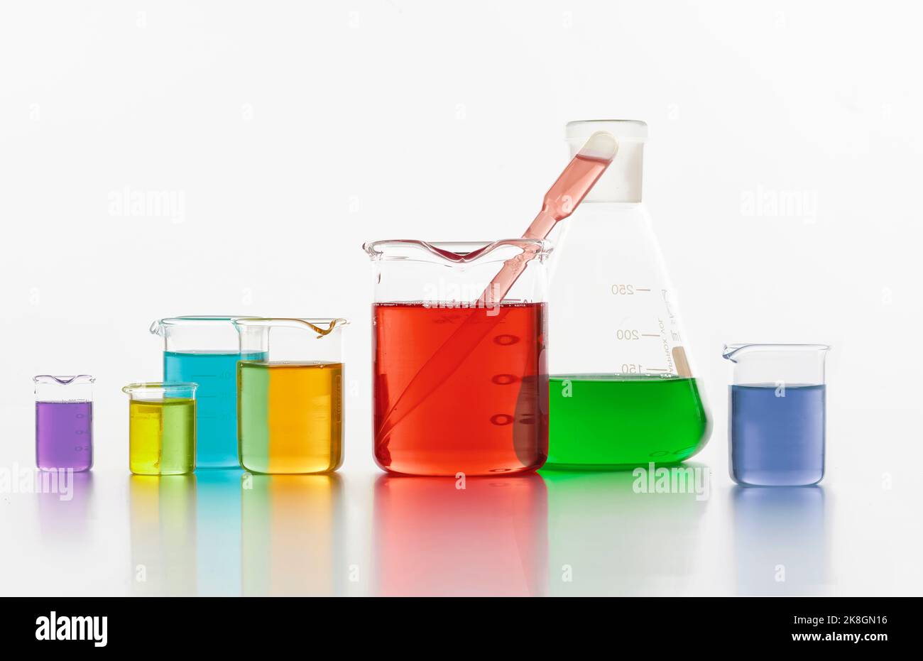 Set of different chemical flasks of various sizes with colorful liquids ...