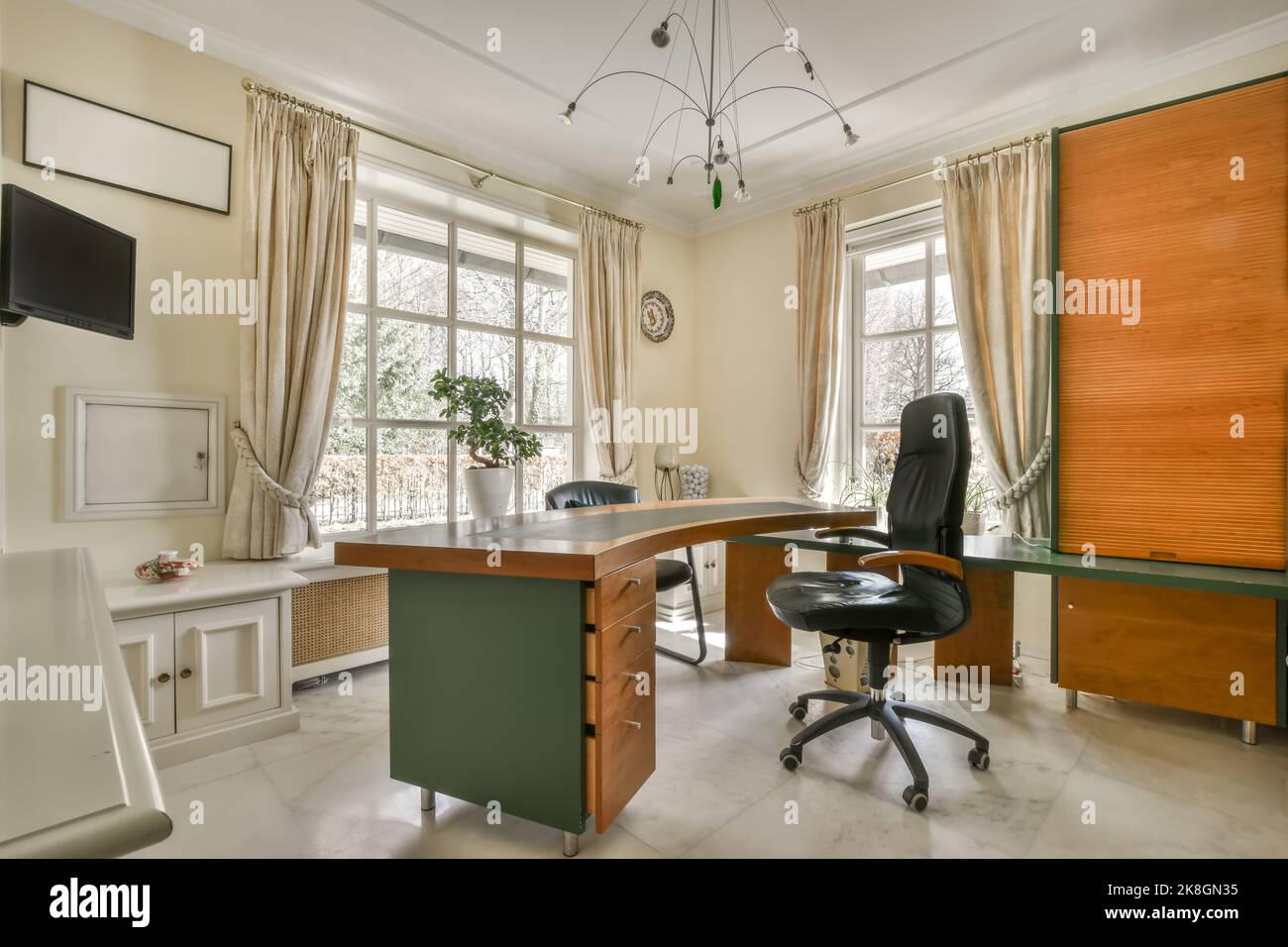 Interior of workplace in residential house with wooden desk and office ...