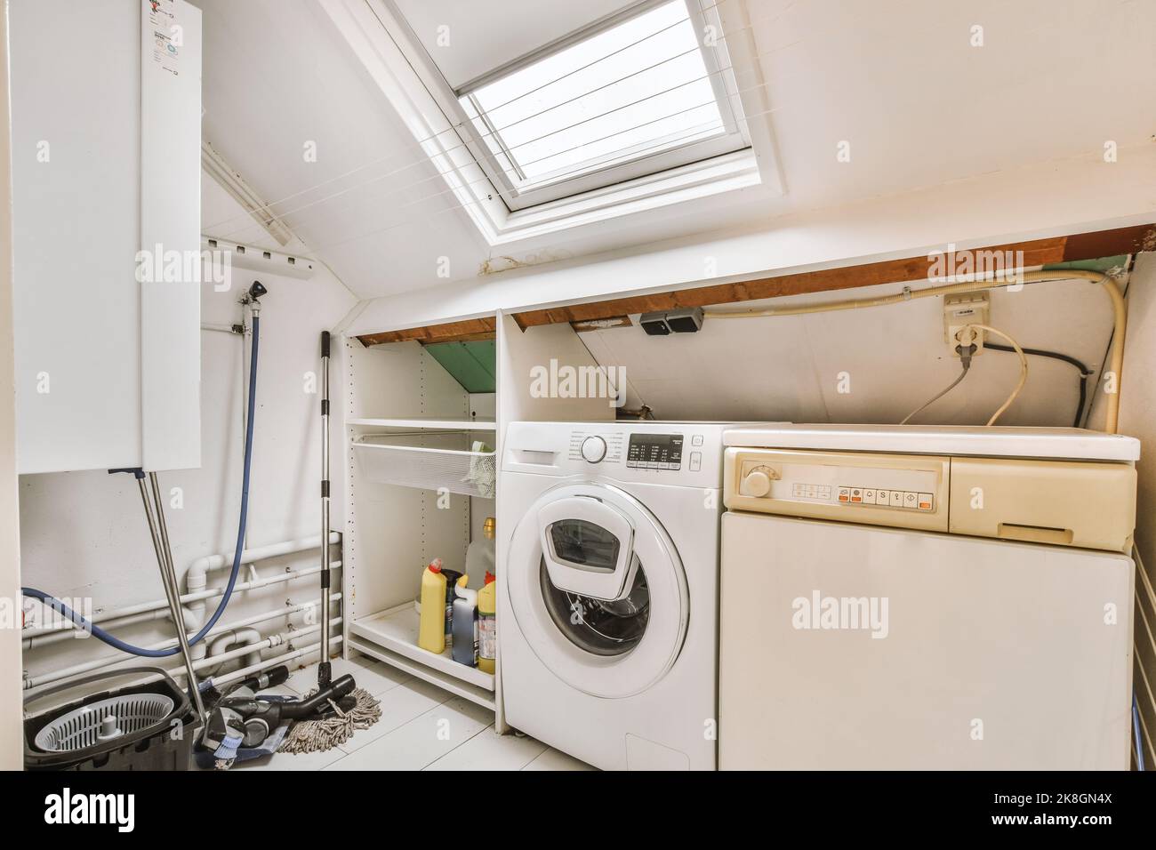 White wardrobe with washing machine in light room at home Stock Photo ...