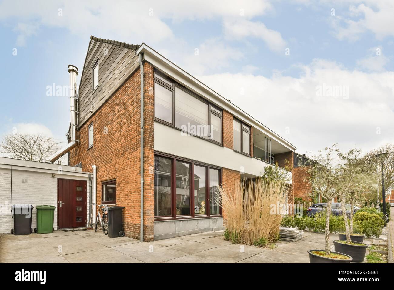 View of a street with houses lined up under a blue sky with clouds ...