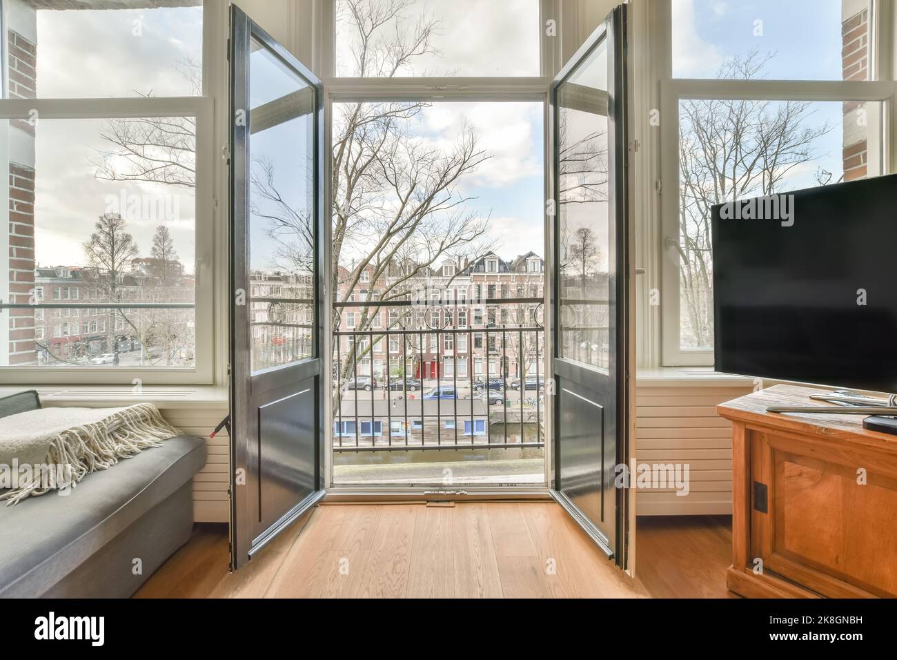 Interior of modern home with furniture next to a open bright window ...