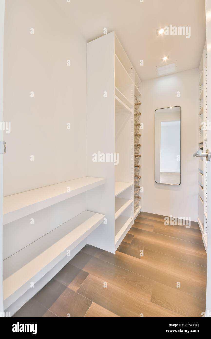 Empty dressing room with laminated flooring full length mirror and ...