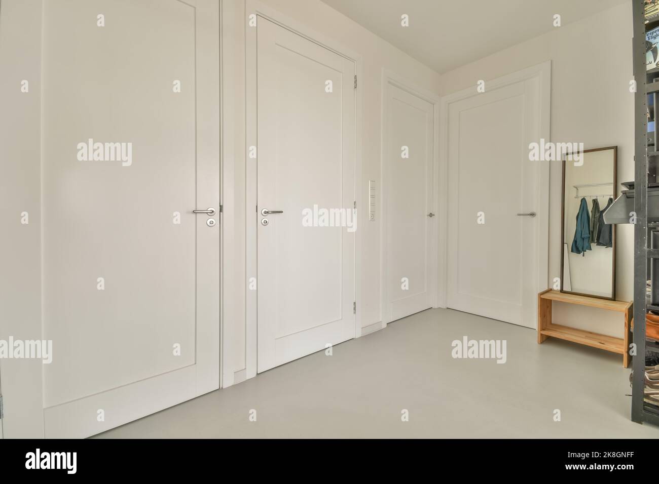 Interior passage way with doors on white walls in modern house Stock ...