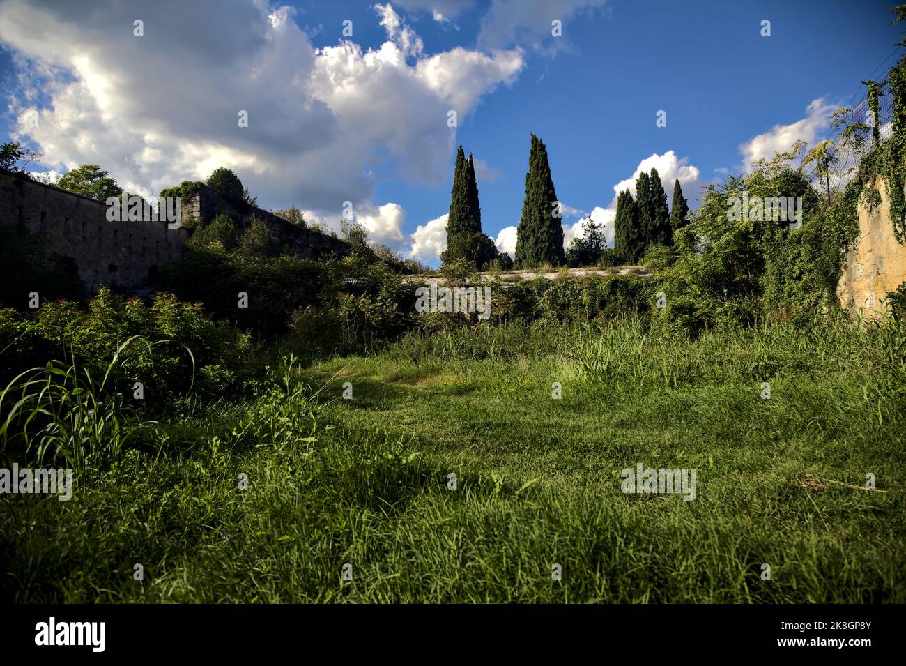 Dirt path next to an abandoned fortification on a sunny day Stock Photo ...