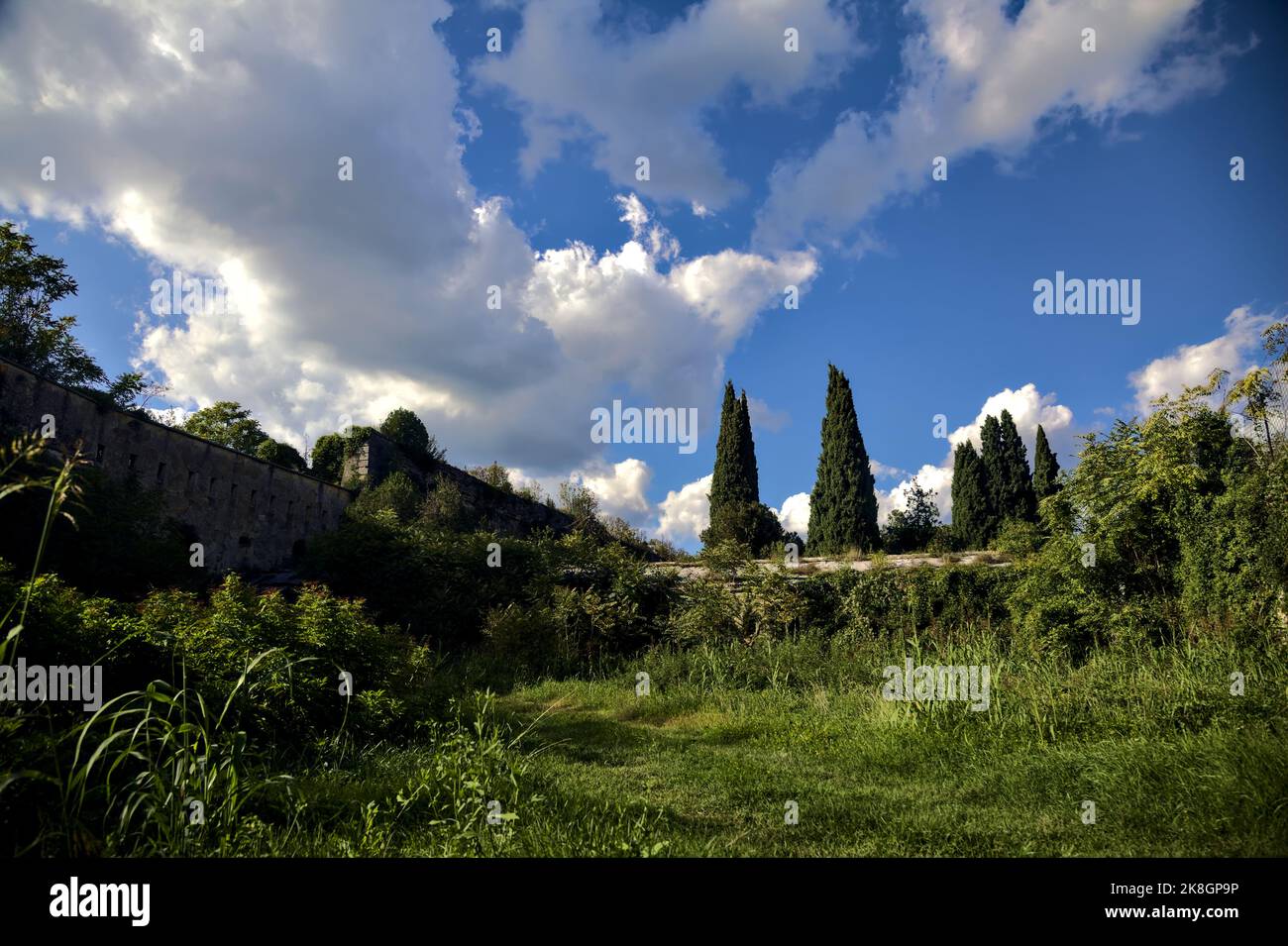 Dirt path next to an abandoned fortification on a sunny day Stock Photo ...