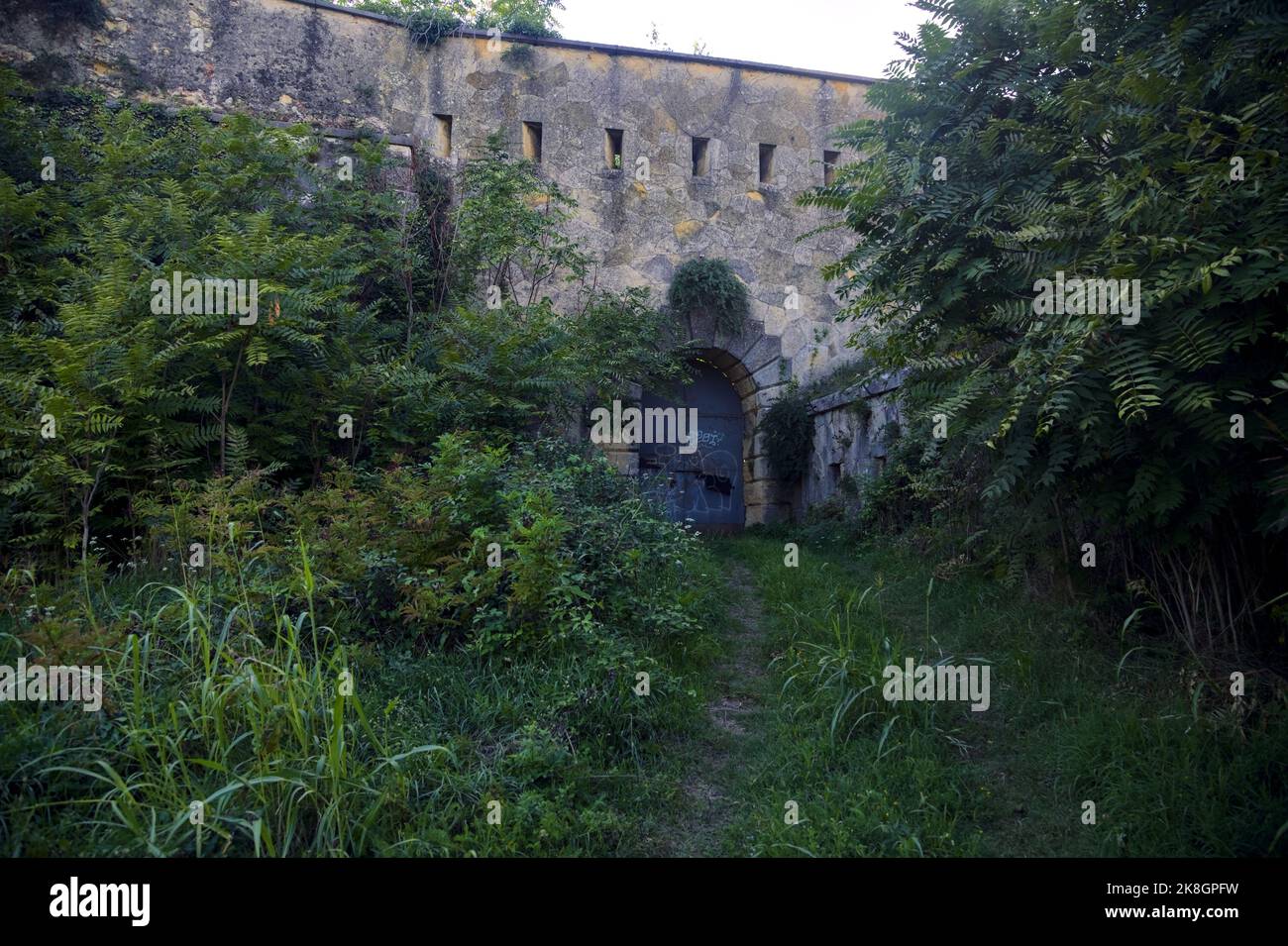 Dirt trail that leads to a closed gate in a fortification Stock Photo ...