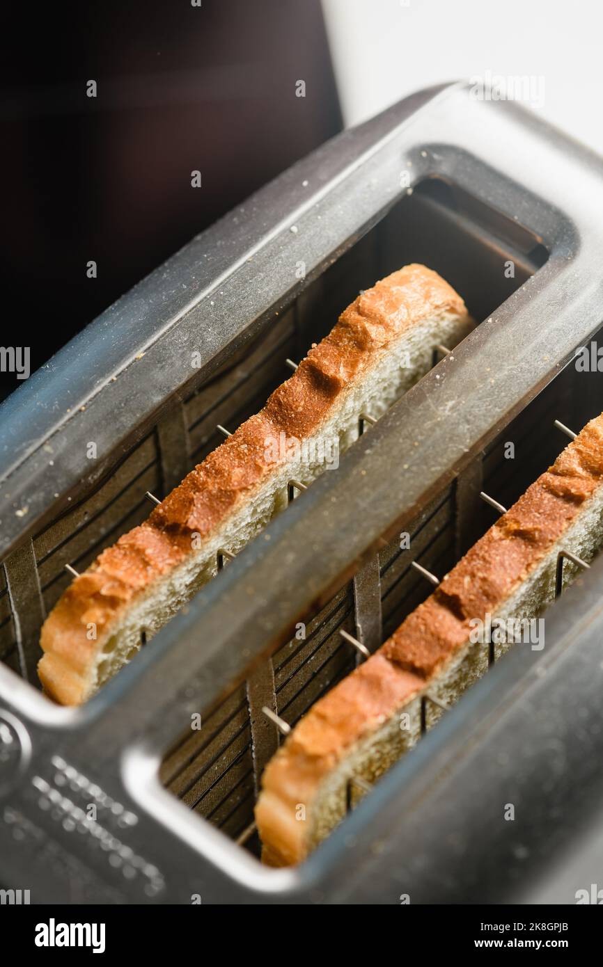 Close-up of two slices of bread in toaster. Top view Stock Photo - Alamy