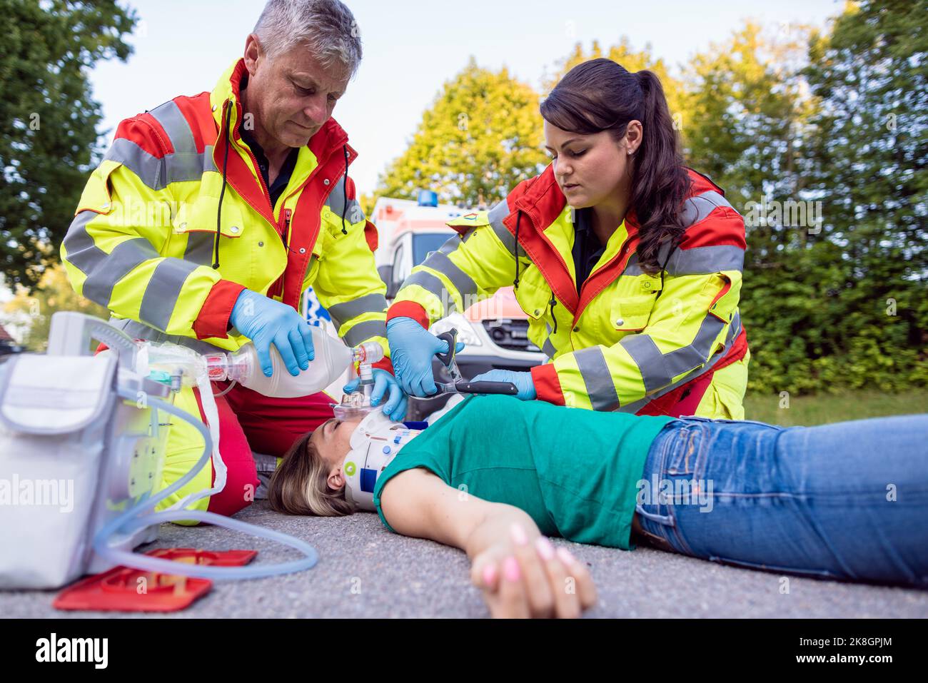 Emergency doctor ventilating injured woman after motorbike accident ...