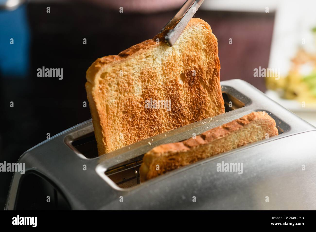 Toaster with toasted bread for breakfast inside. Close-up Stock Photo ...