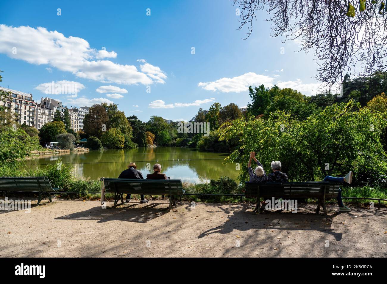 Parisians sunbathing on the shore of the lake of Parc Montsouris ...