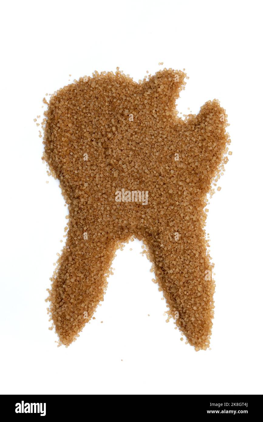 top view of unrefined natural brown sugar is laid out in form of tooth ...