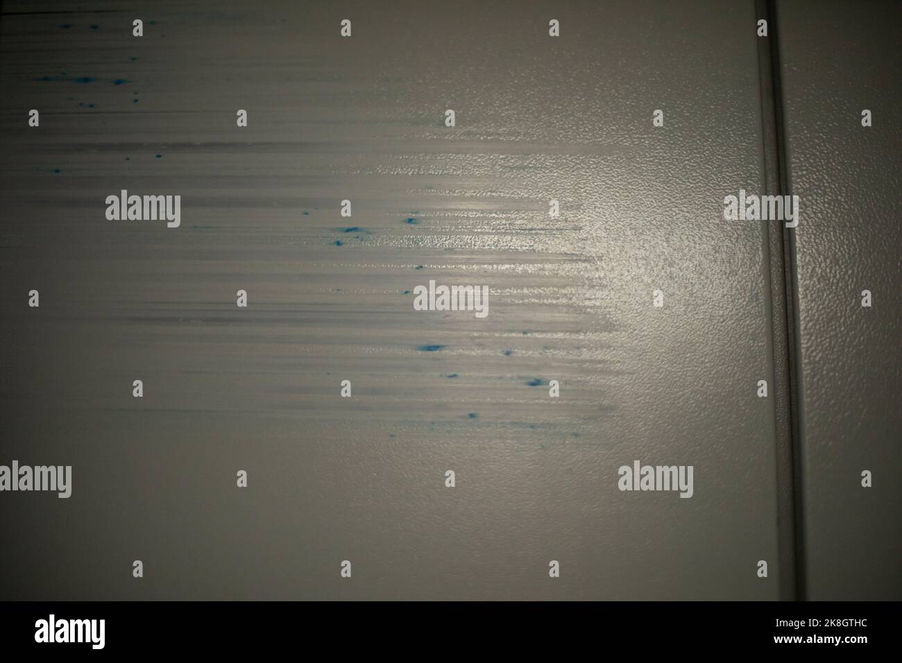 Scratched surface. Damaged paint on wall. Traces of grinding. Lines on ...