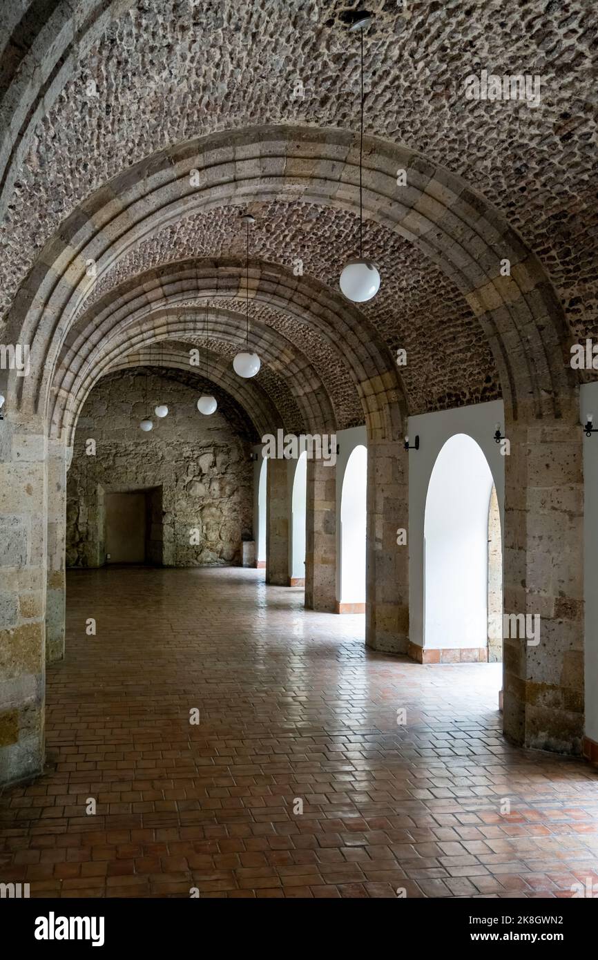 corridor with stone arcades natural light from the side, colonial ...