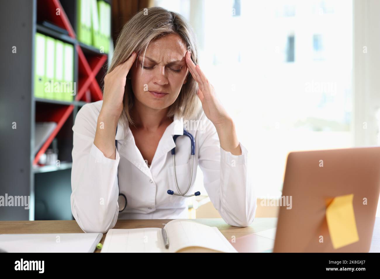 Frustrated doctor touching temples and closed eyes Stock Photo - Alamy