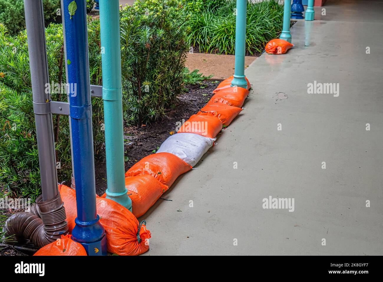 Sand bags laid at the edge of a path before a strong storm Stock Photo ...