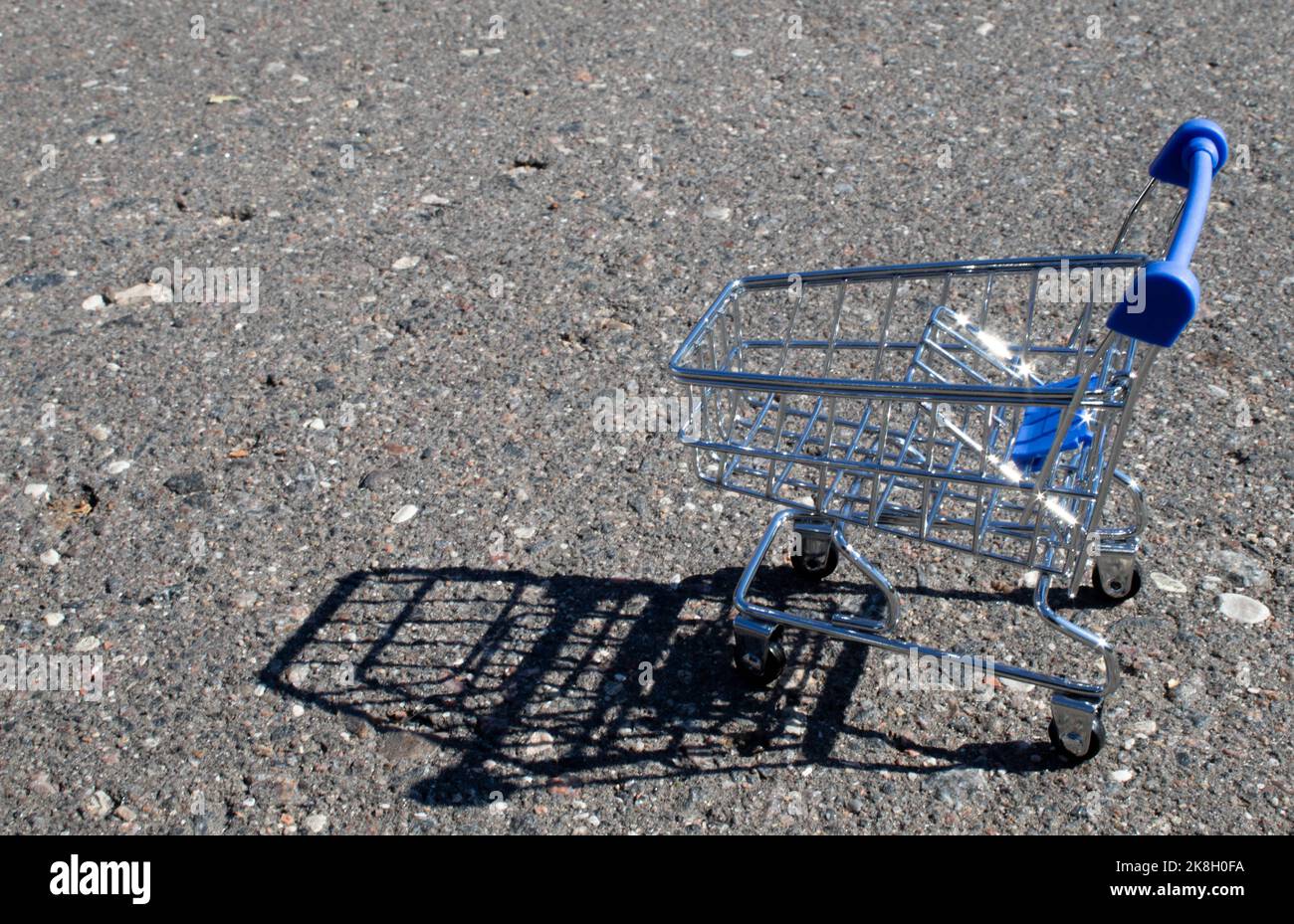 Empty grocery cart in an empty parking lot near a supermarket Stock ...
