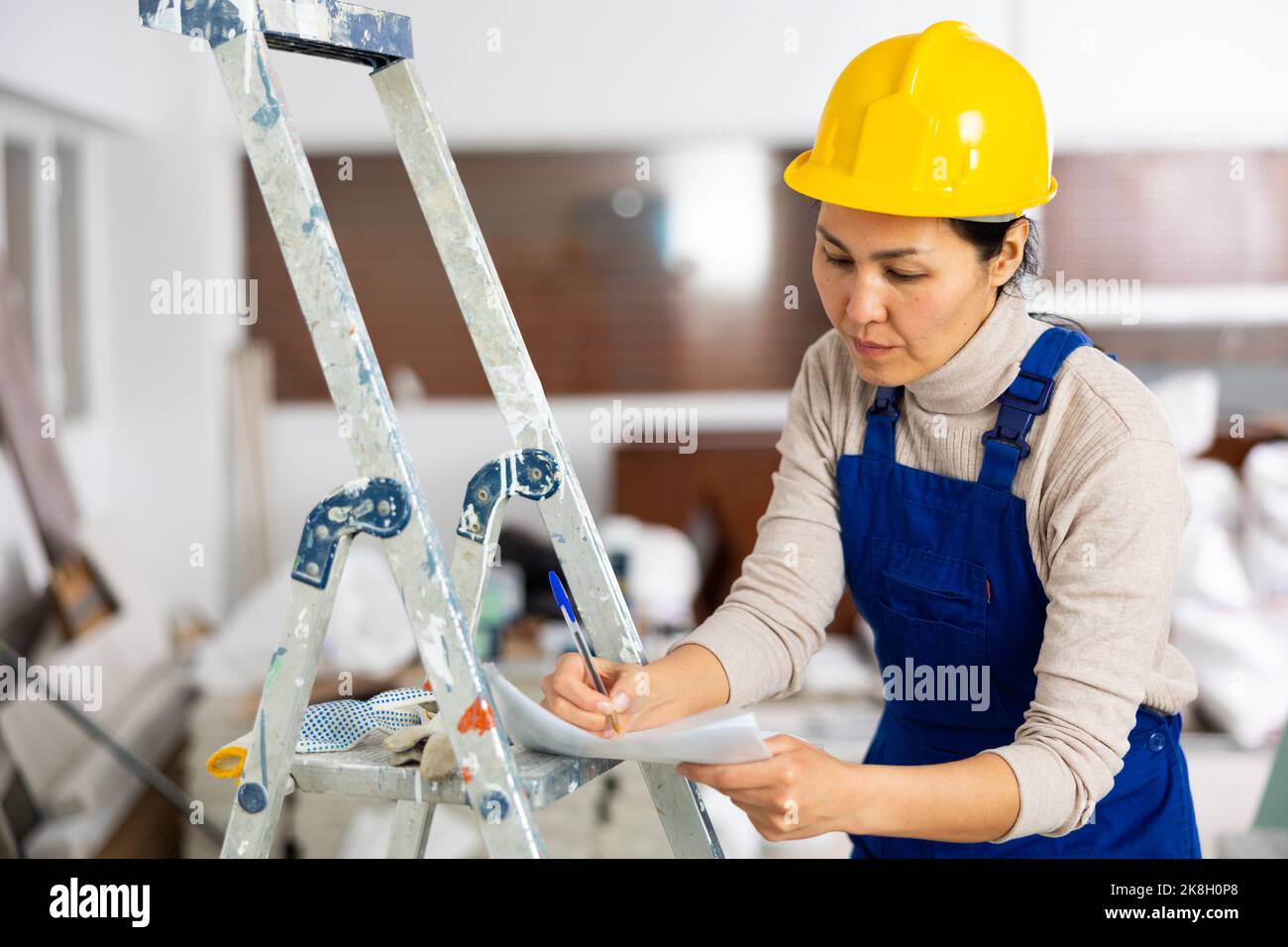 Woman signs an act of acceptance of completed work Stock Photo - Alamy