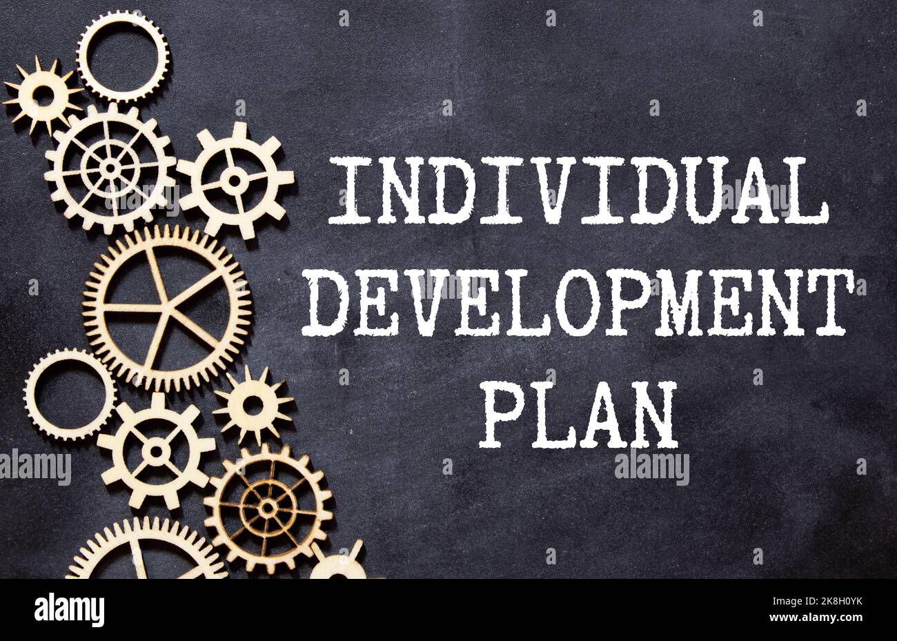 Closeup on businessman holding a card with text INDIVIDUAL DEVELOPMENT ...