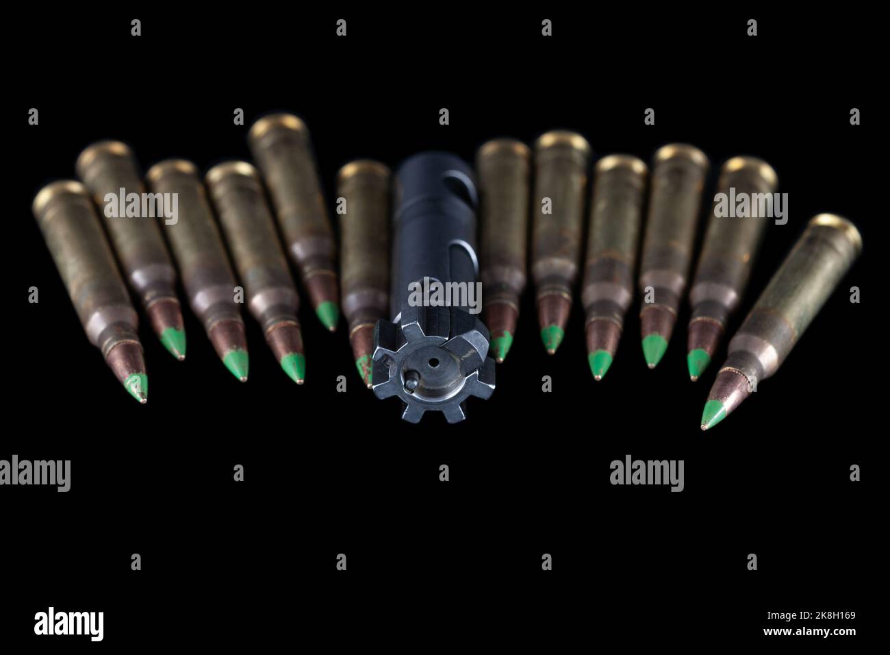 5.56mm NATO ammunition with assault rifle bolt on black background ...