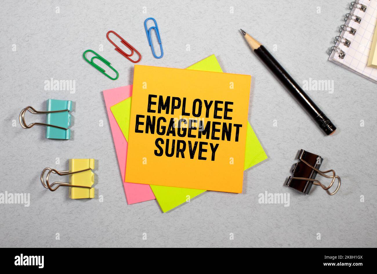 Employee Engagement Survey sign written on sticky note pinned on wooden ...
