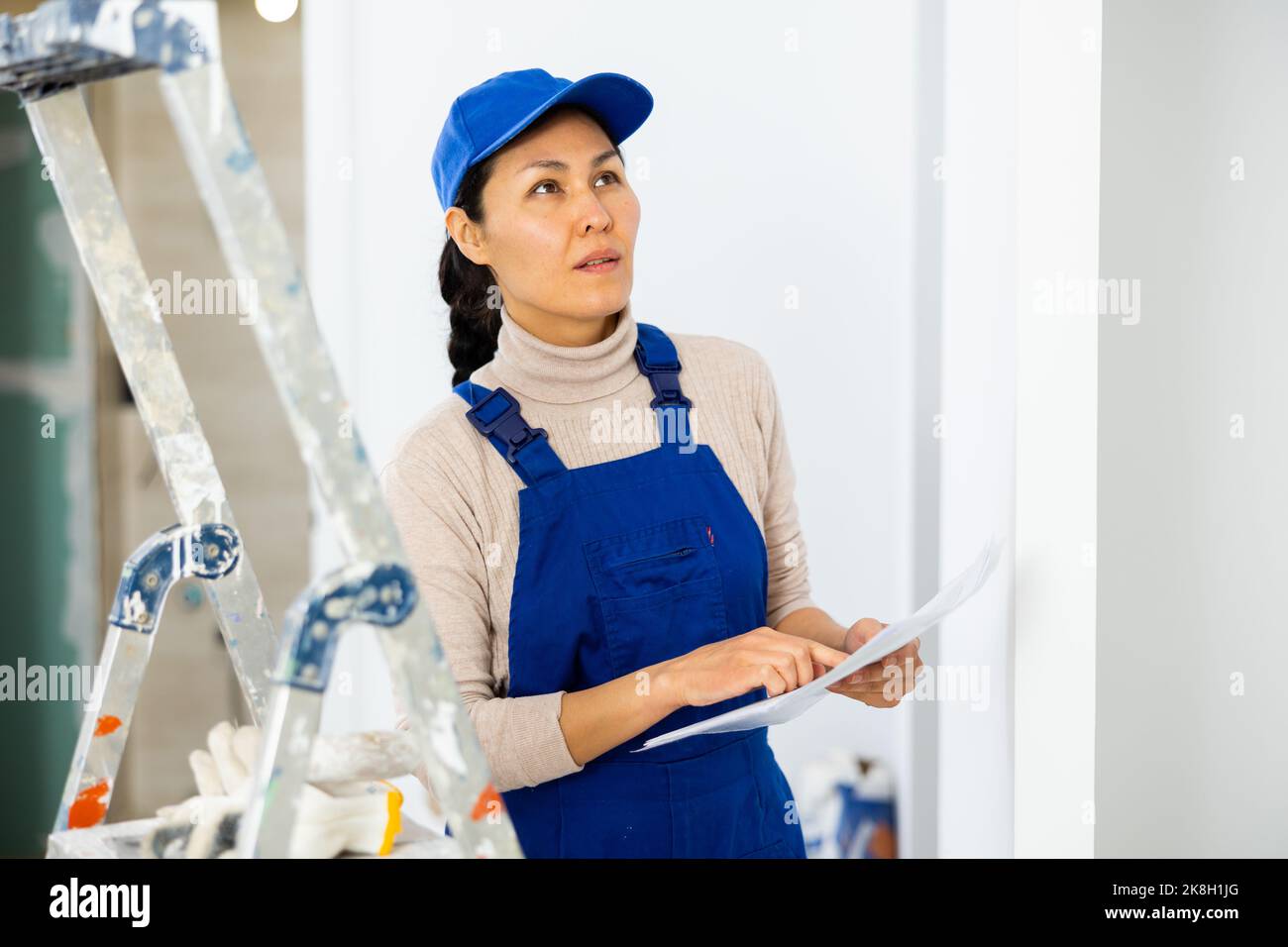 Female engineer matching check list during repair works Stock Photo - Alamy