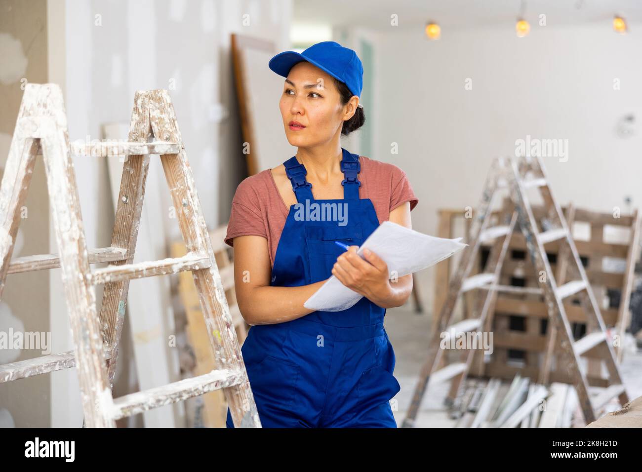 Female engineer matching check list during repair works Stock Photo - Alamy
