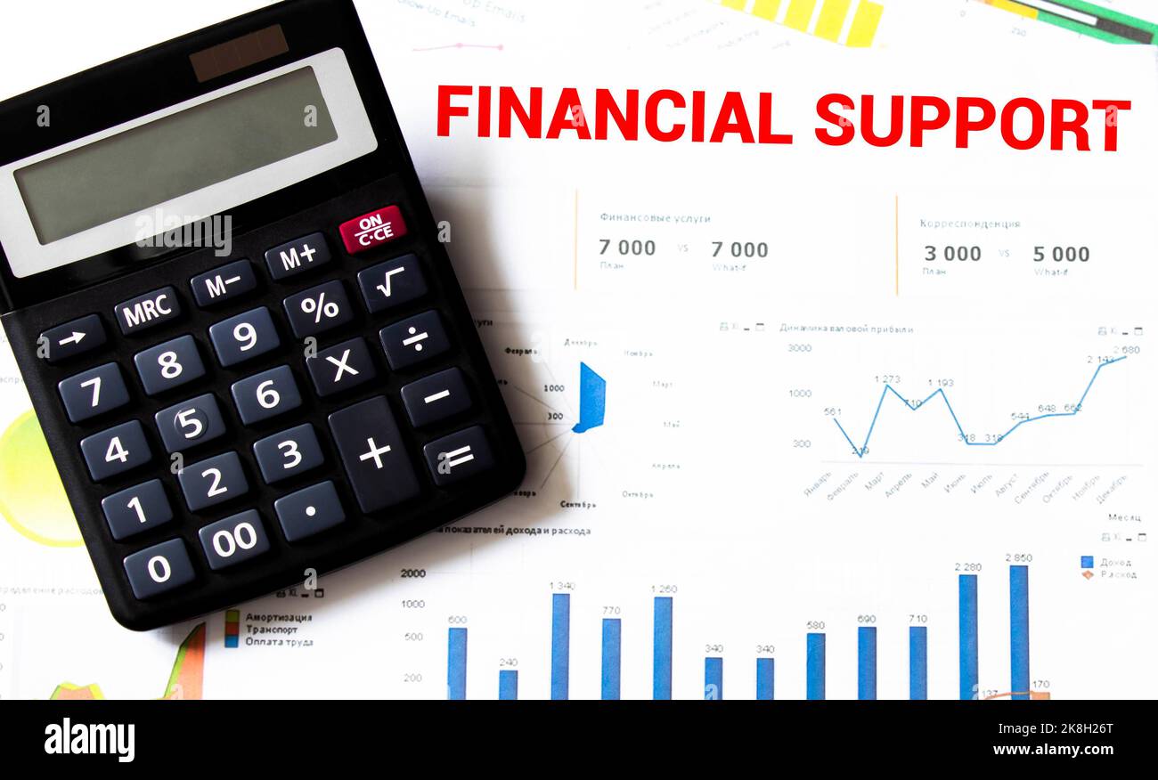 The desktop contains colored tables, a calculator, glasses, a pen and a ...