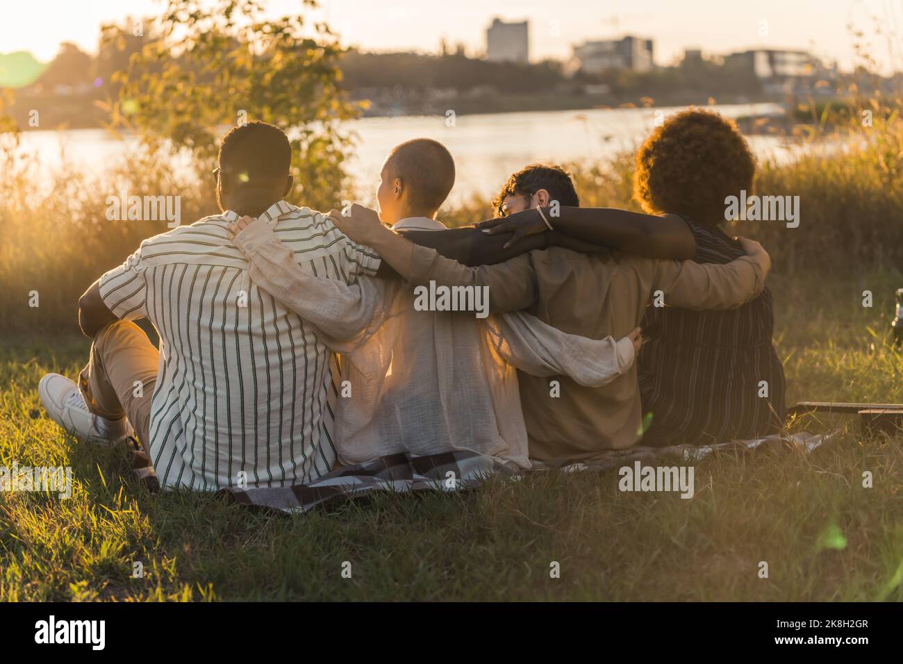 Beauty of friendship bond. Outdoor shot. Group of people sitting by the ...
