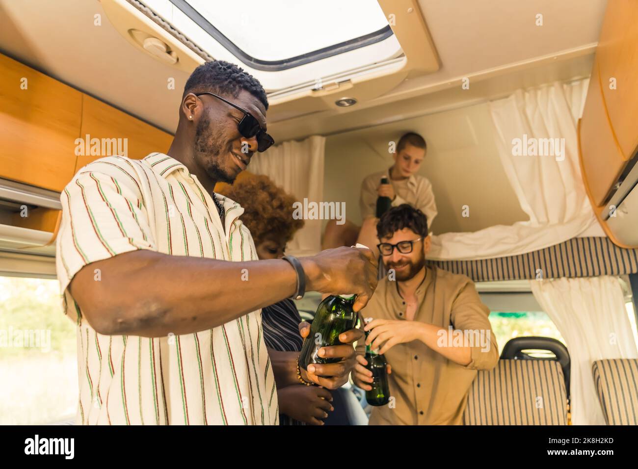Handsome chill Black man in sunglasses and short-sleeved stripped shirt ...