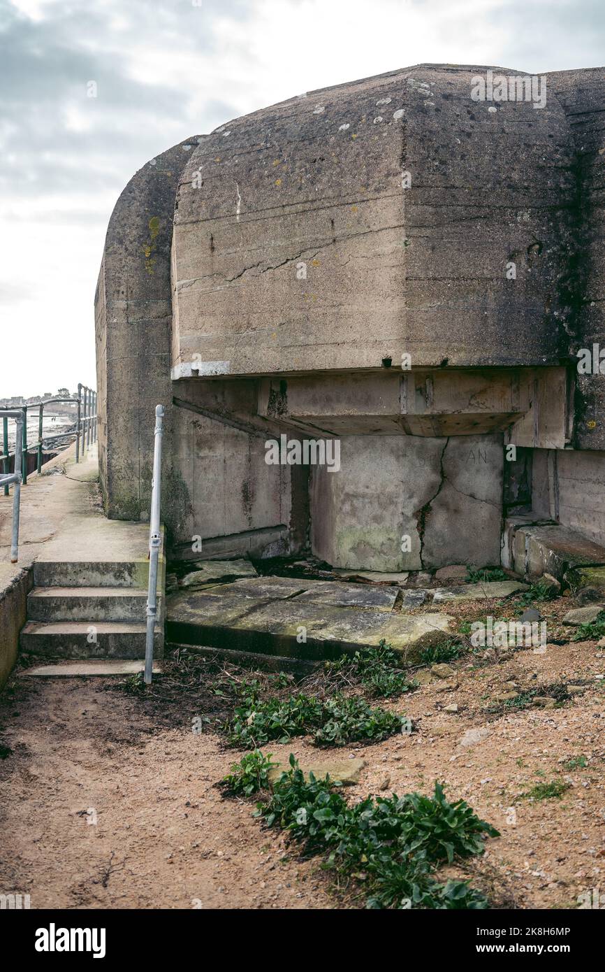 Abandoned World War II bunker on the cliffs of the island on cloudy day ...