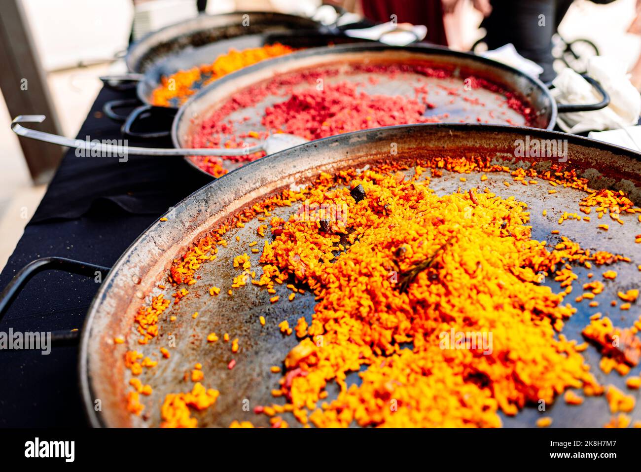 Variety of types of Valencian paellas with rice of different colors and ...