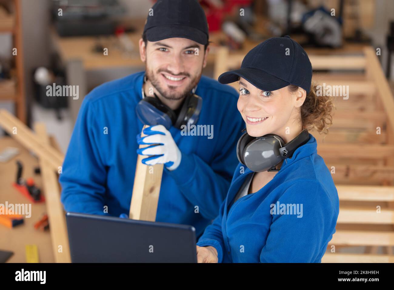 male worker teaching female apprentice how to operate a machine Stock ...