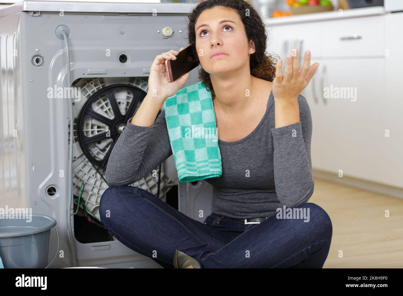 woman calling for appliance repair service Stock Photo - Alamy