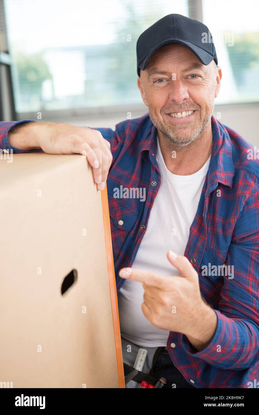 delivery man pointing to stack of boxes i Stock Photo - Alamy