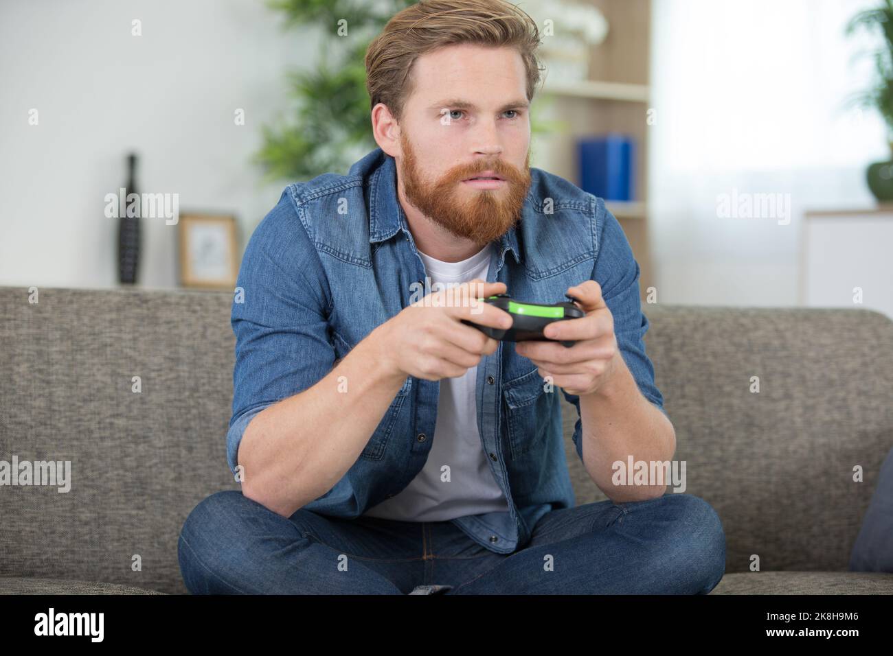 young man with joystick controller for console playing Stock Photo - Alamy