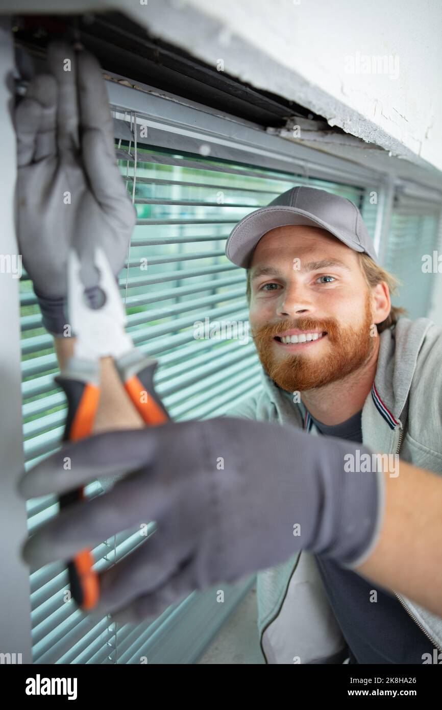 workman using pliers on a damaged window lintel Stock Photo - Alamy