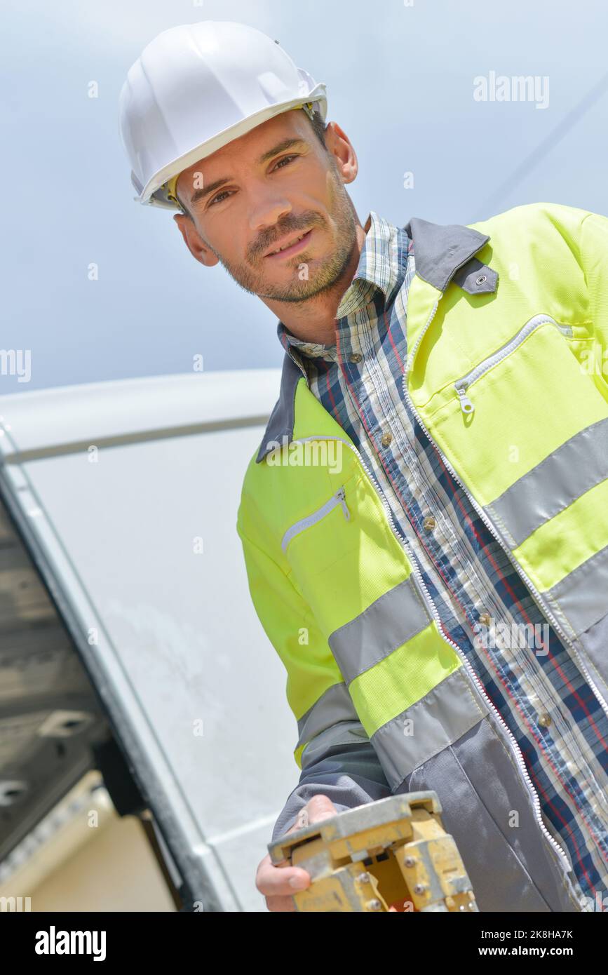 a young attractive builder outdoors Stock Photo - Alamy