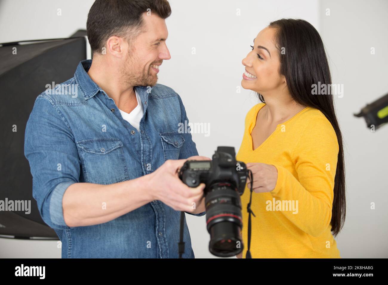 photographer and model reviewing photoson camera Stock Photo - Alamy