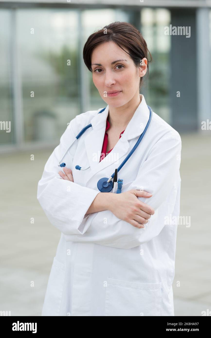 portrait of female doctor standing outside hospital Stock Photo - Alamy