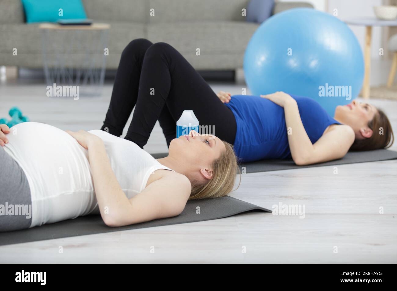 two pregnant women lay down in maternity class Stock Photo - Alamy