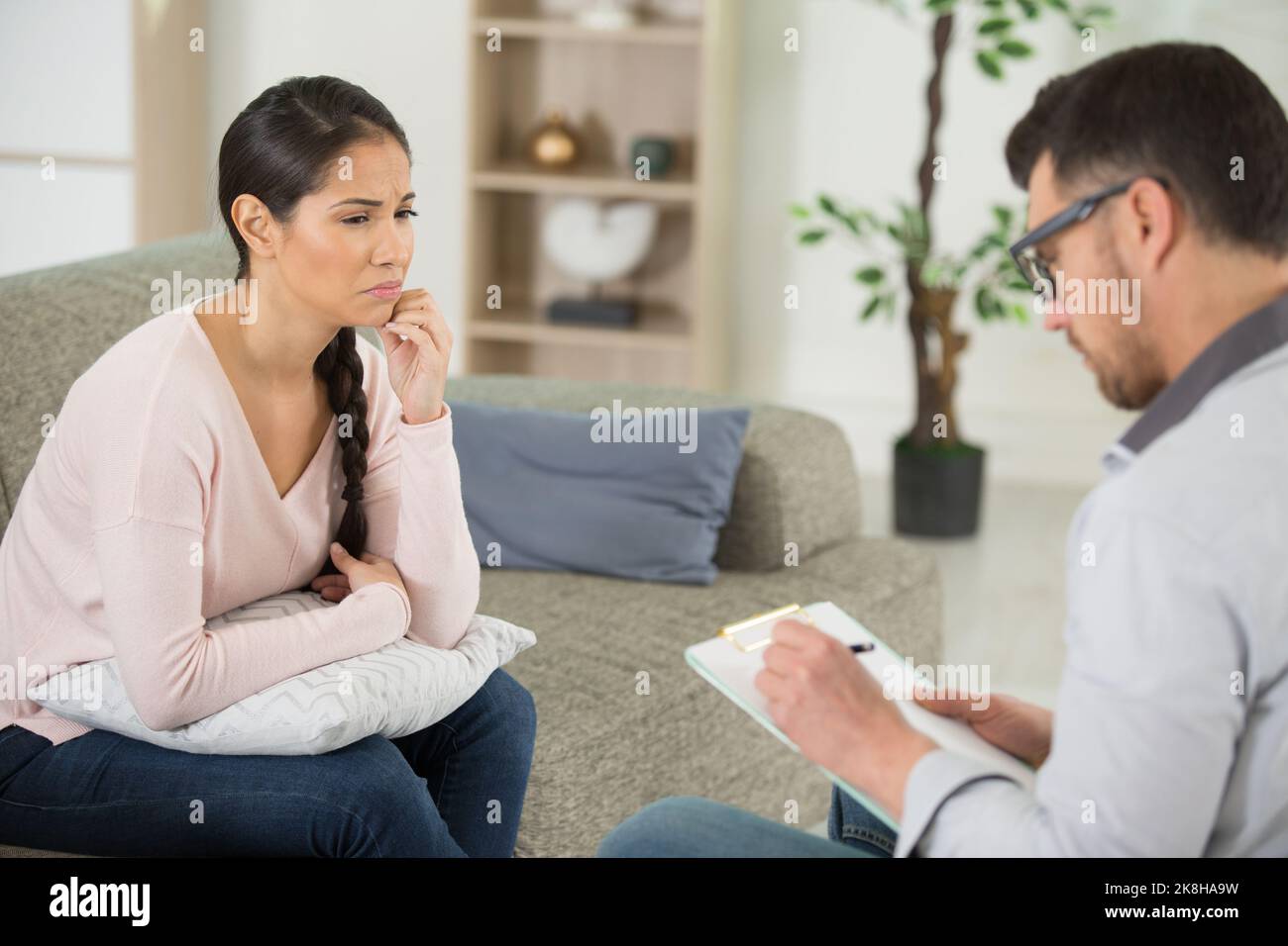 unhappy sad woman in consultation with a psychologist Stock Photo - Alamy