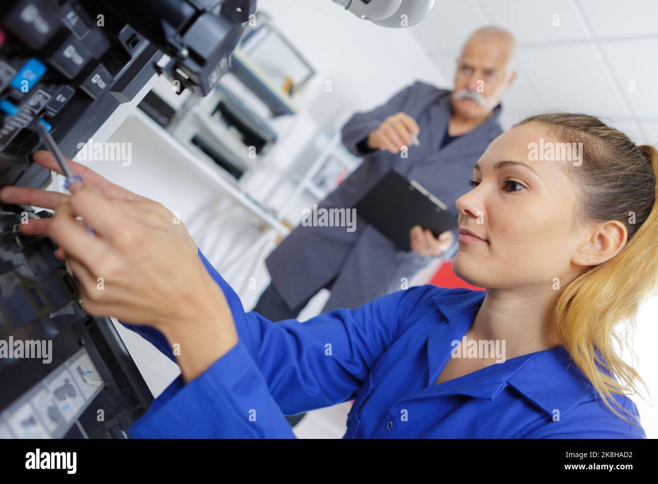 female technician fixing a printer Stock Photo - Alamy