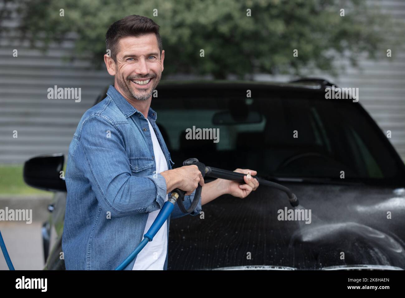 washing luxury car with water gun Stock Photo - Alamy