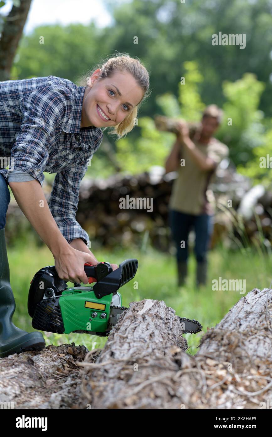 a woman cutting wood outdoors Stock Photo - Alamy