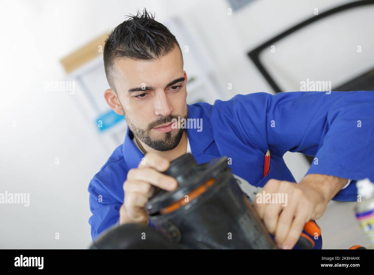 Mechanic inspecting vehicle part hi-res stock photography and images ...