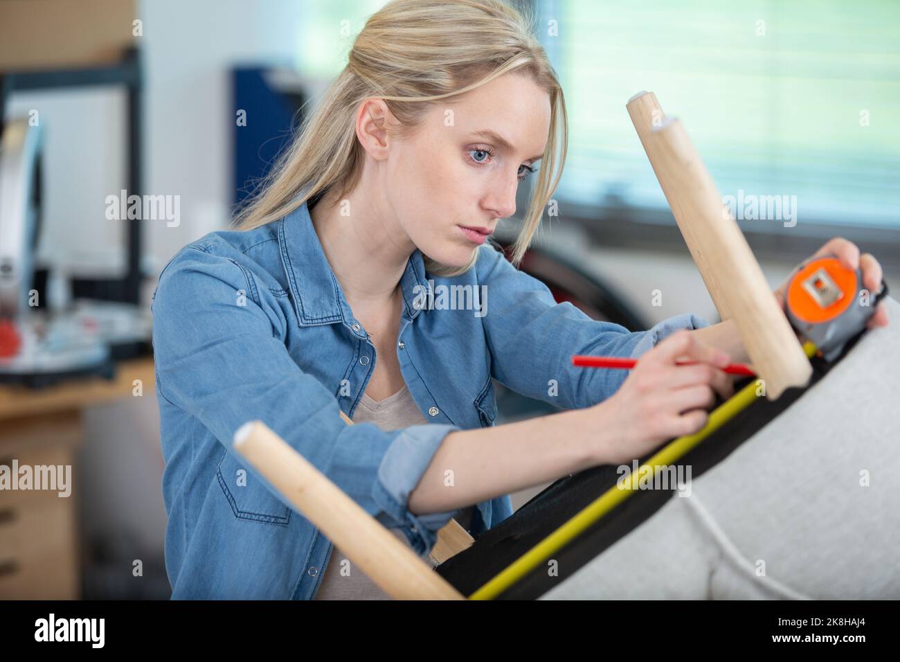 woman repairing chair is measuring the base Stock Photo - Alamy
