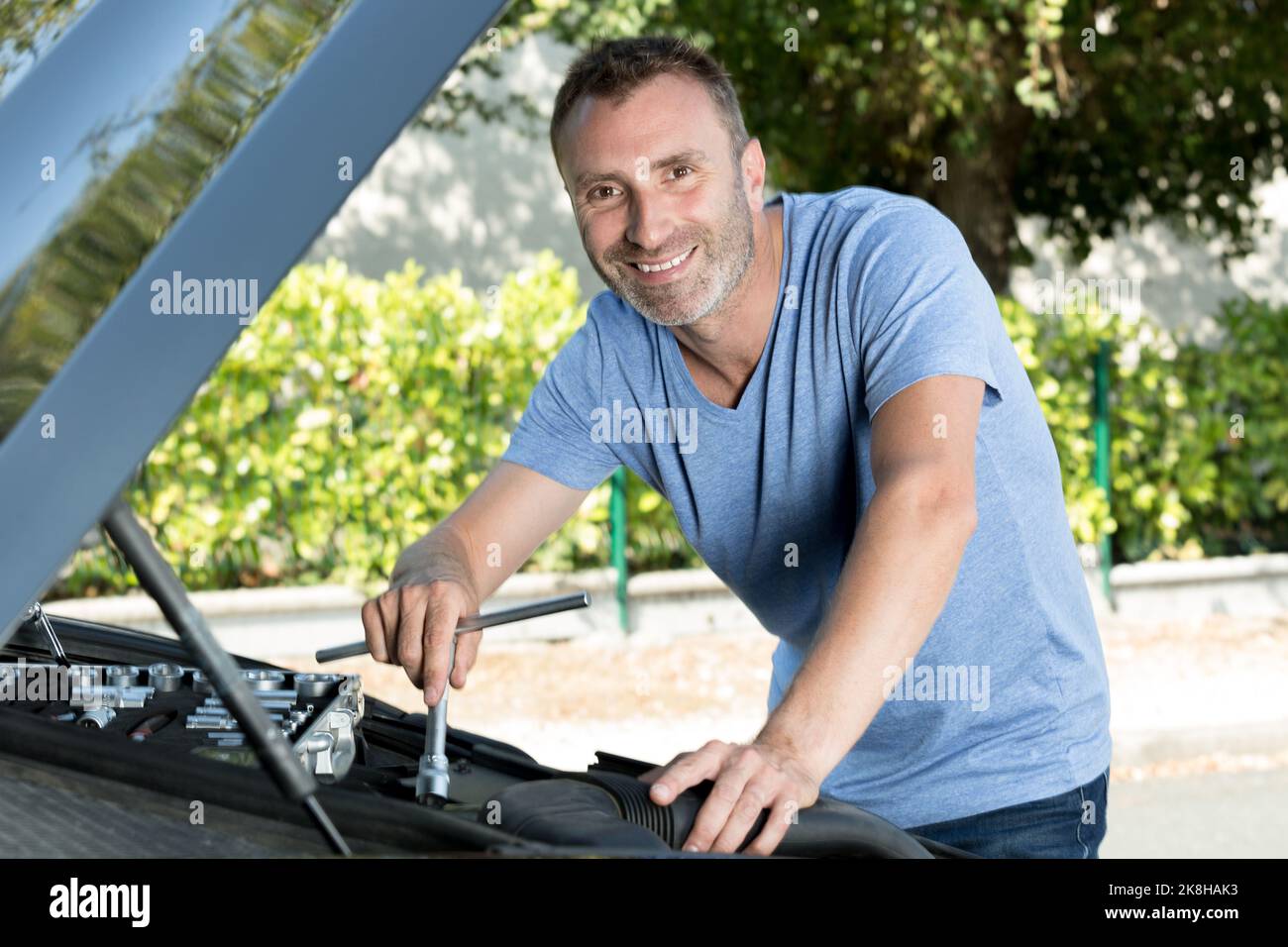 happy man touches engine of his car Stock Photo - Alamy
