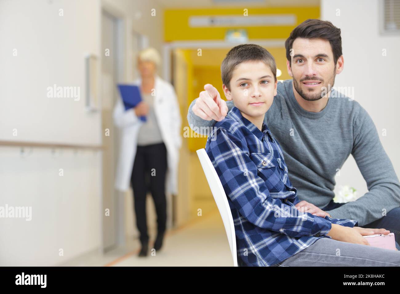 kid patient and his dad in waiting area Stock Photo - Alamy